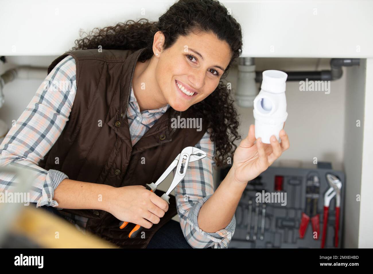 female plumber holding and showing pipe fitting Stock Photo - Alamy