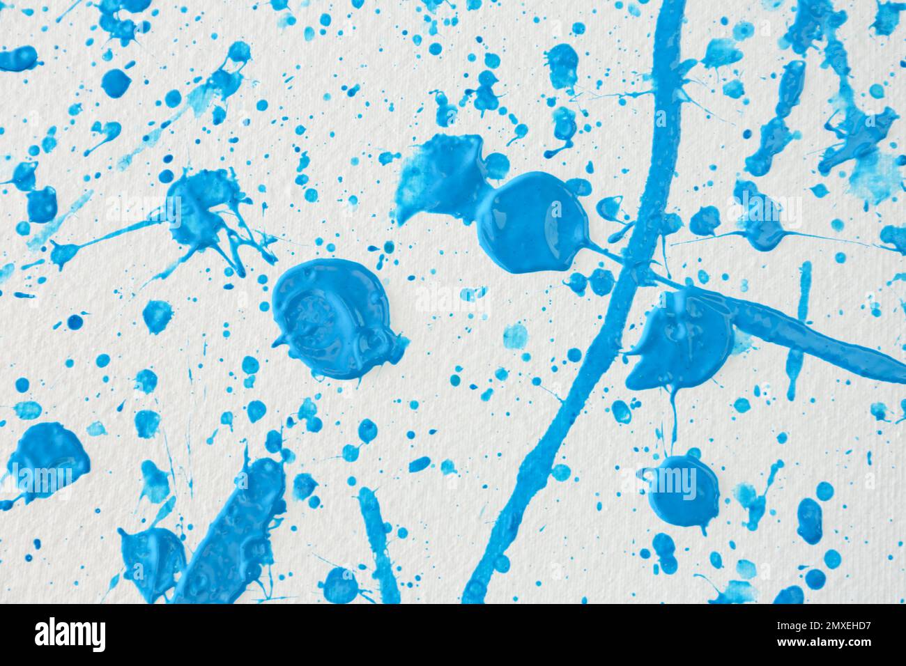 Blue paint splashes on white canvas as background. Art and creativity ...