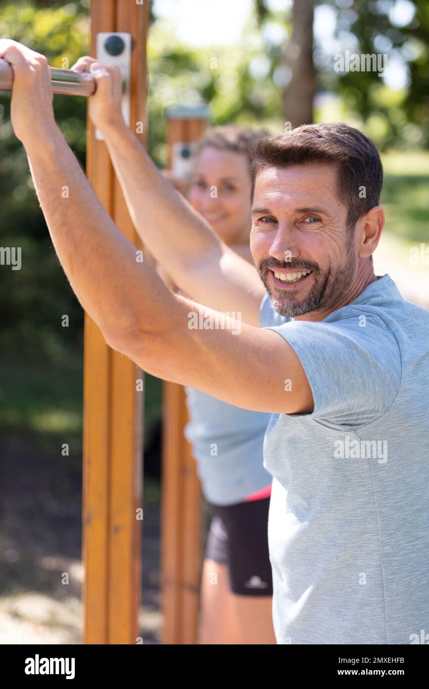 active couple exercise on park gym outdoors Stock Photo - Alamy