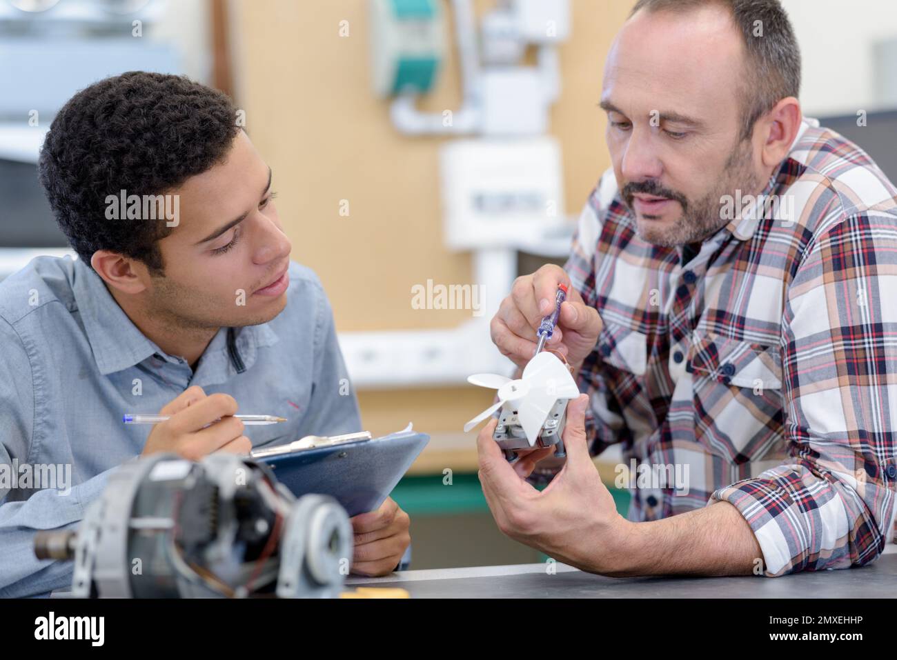 men fixing a robotic machine Stock Photo - Alamy