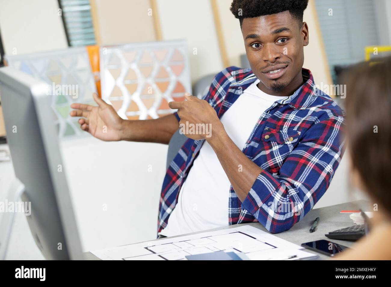 cheerful master howing ceramic square tile samples Stock Photo - Alamy
