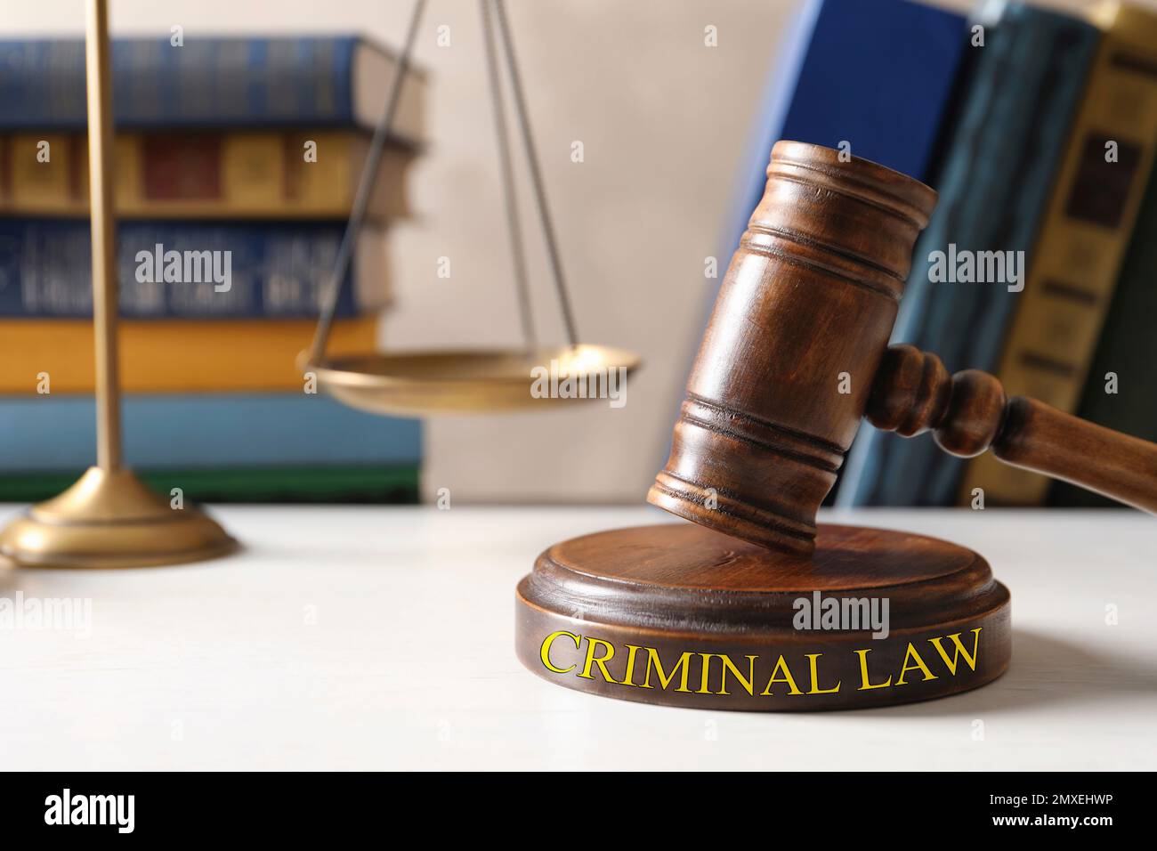 Wooden gavel, scales of justice and books on table. Criminal law ...