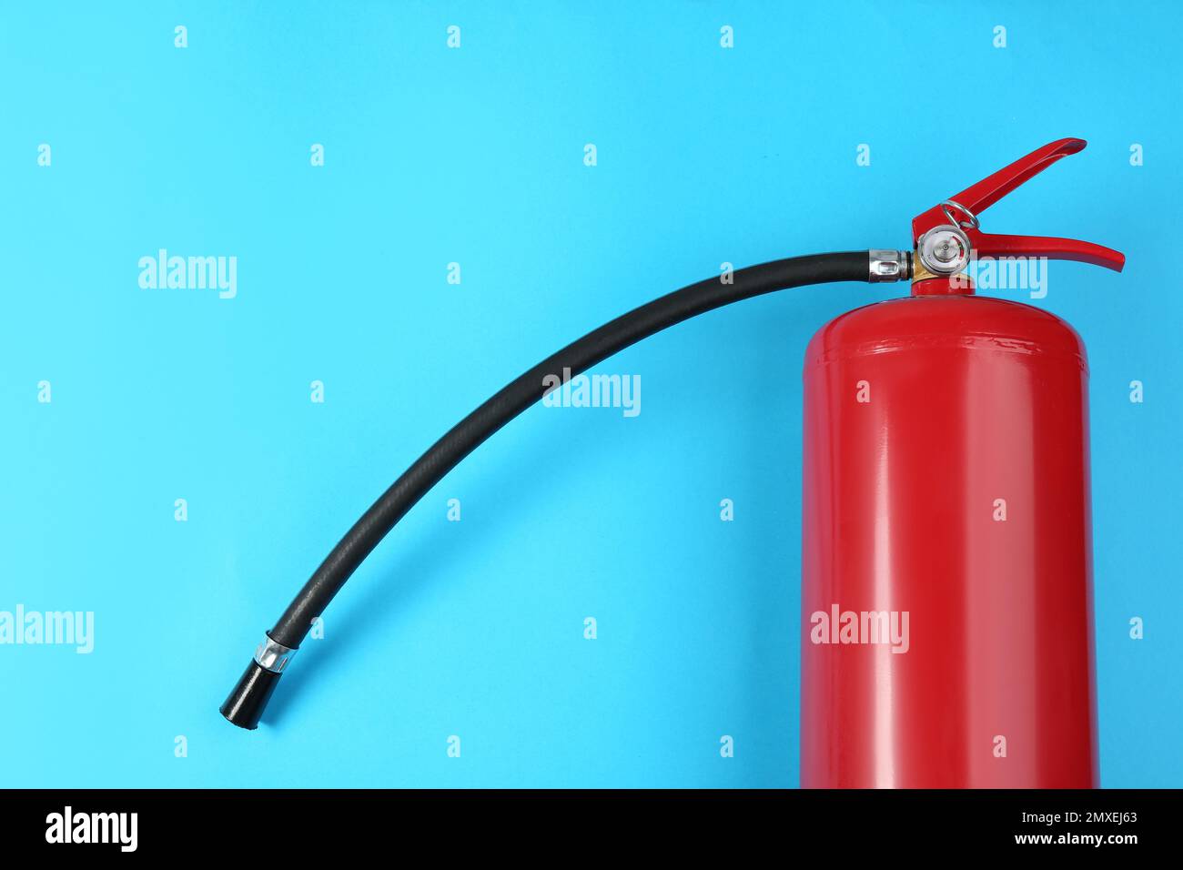 Fire extinguisher on light blue background, top view Stock Photo - Alamy