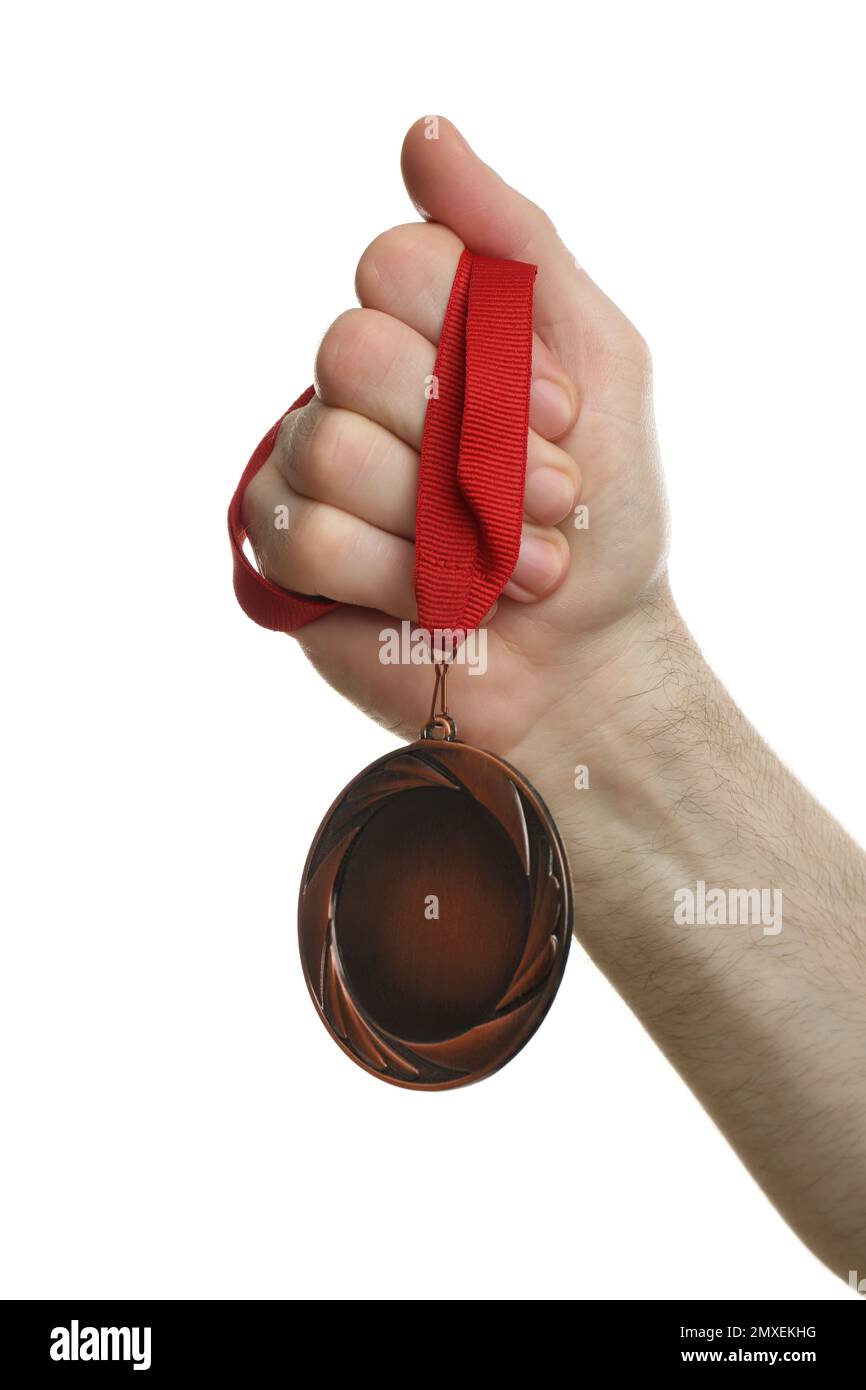 Man holding golden medal on white background, closeup. Space for design ...