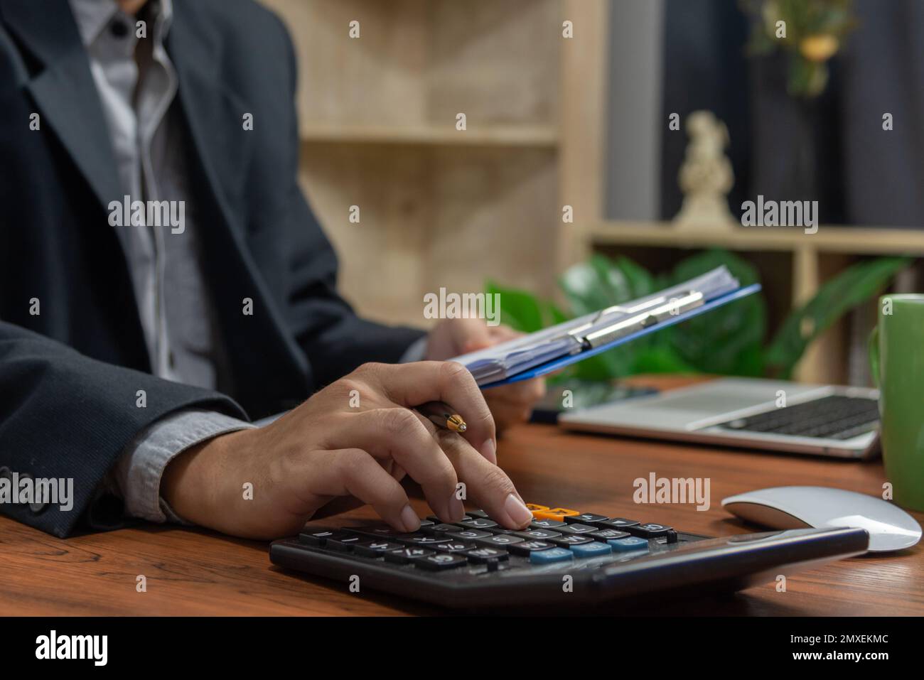 Hand businessman doing finances and calculate on desk about cost at ...