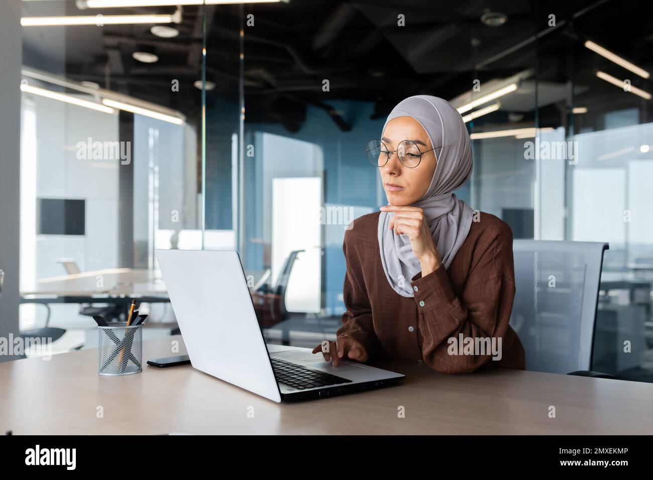 Successful businesswoman thinking at workplace, muslim woman in hijab ...