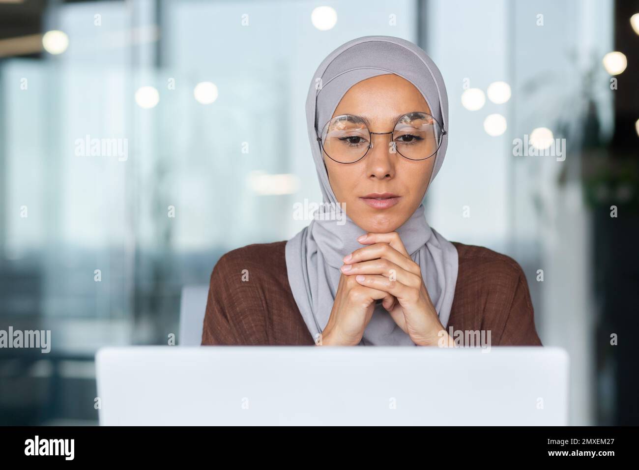 Successful businesswoman thinking at workplace, muslim woman in hijab ...