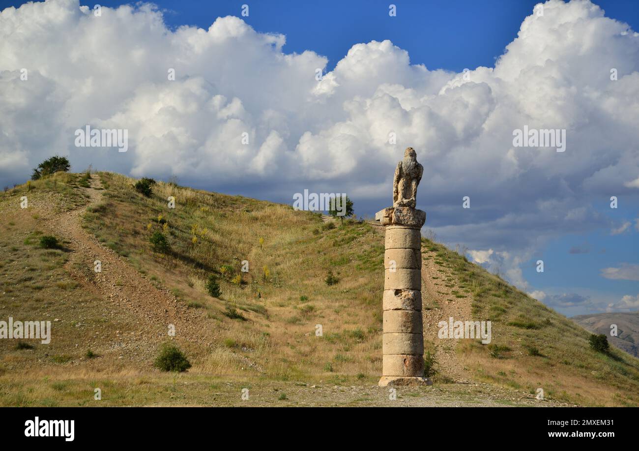 The eagle-topped column in Karakus Tumulus with a cloudy blue sky in ...