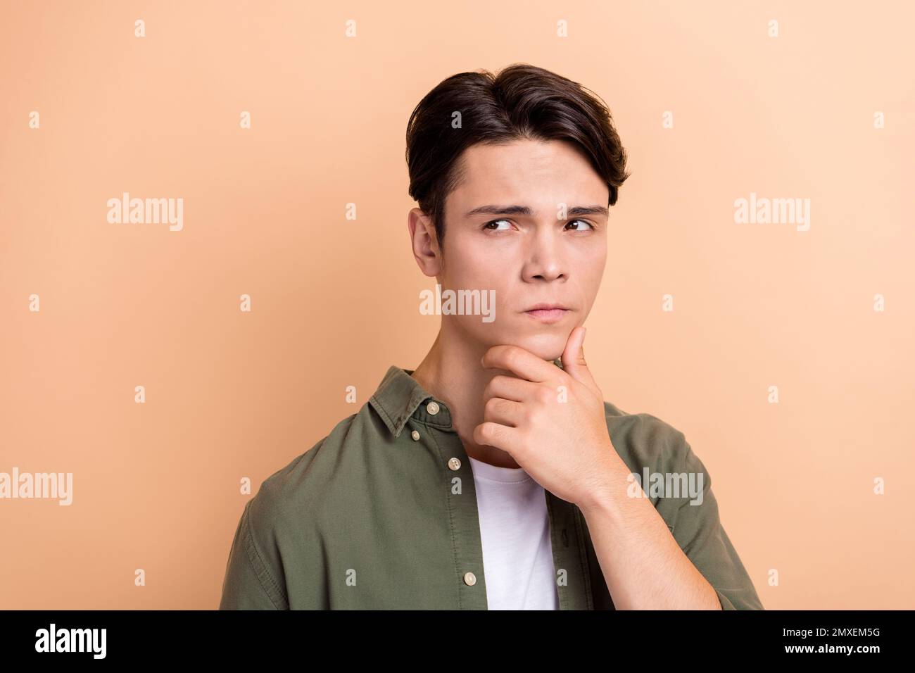 Portrait of handsome clever man with brunet haircut dressed khaki shirt ...