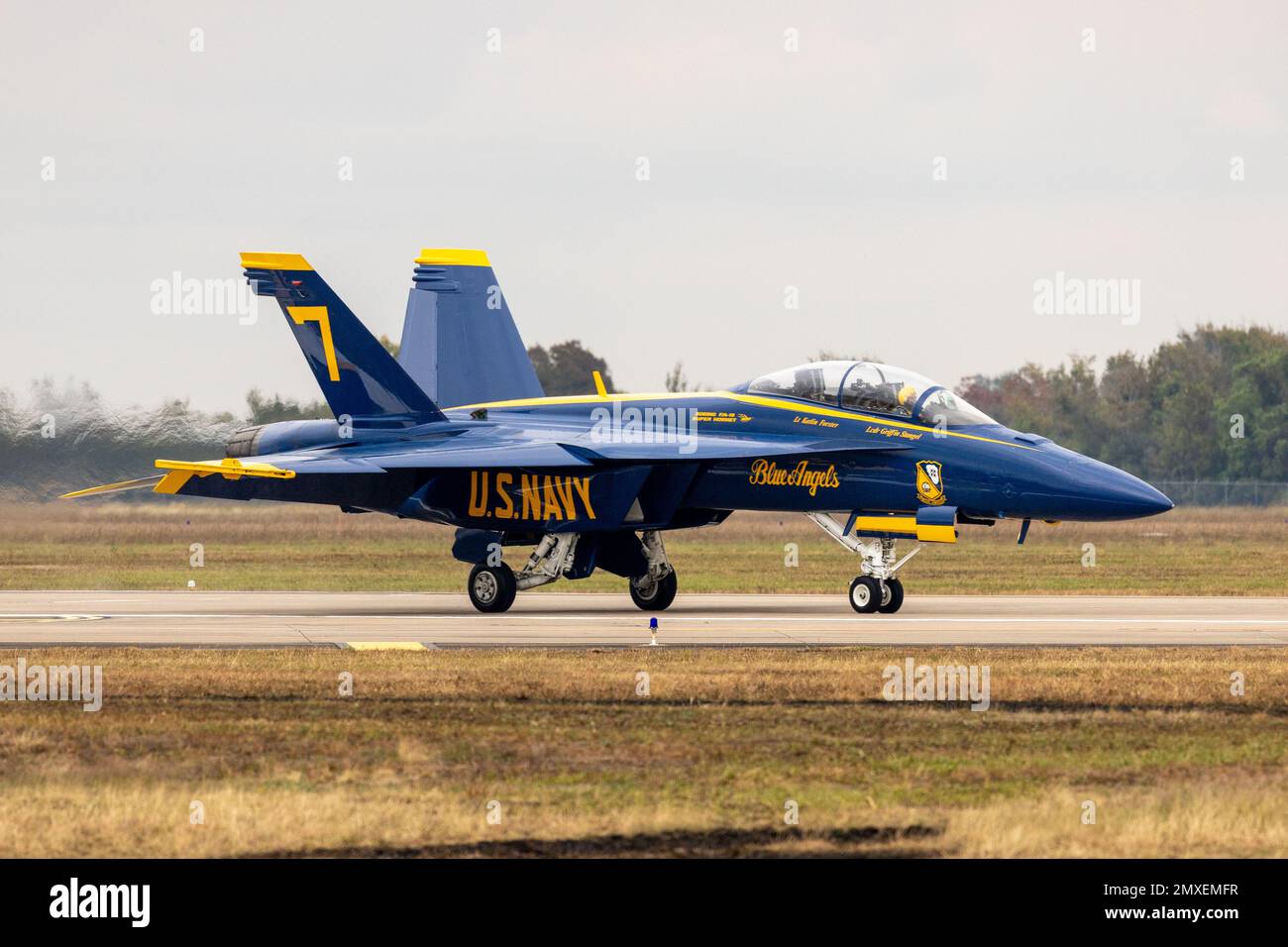 The Blue Angel 7 airplane parked with a cloudy sky in the background ...
