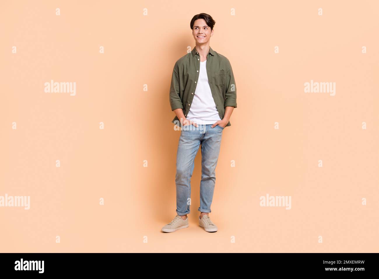 Full body size photo of young cheerful guy dreaming looking empty space ...