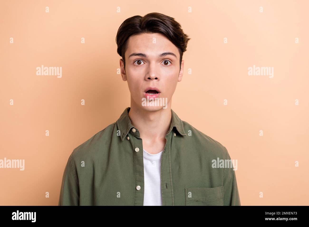 Photo of handsome astonished impressed guy with brunet hair dressed ...