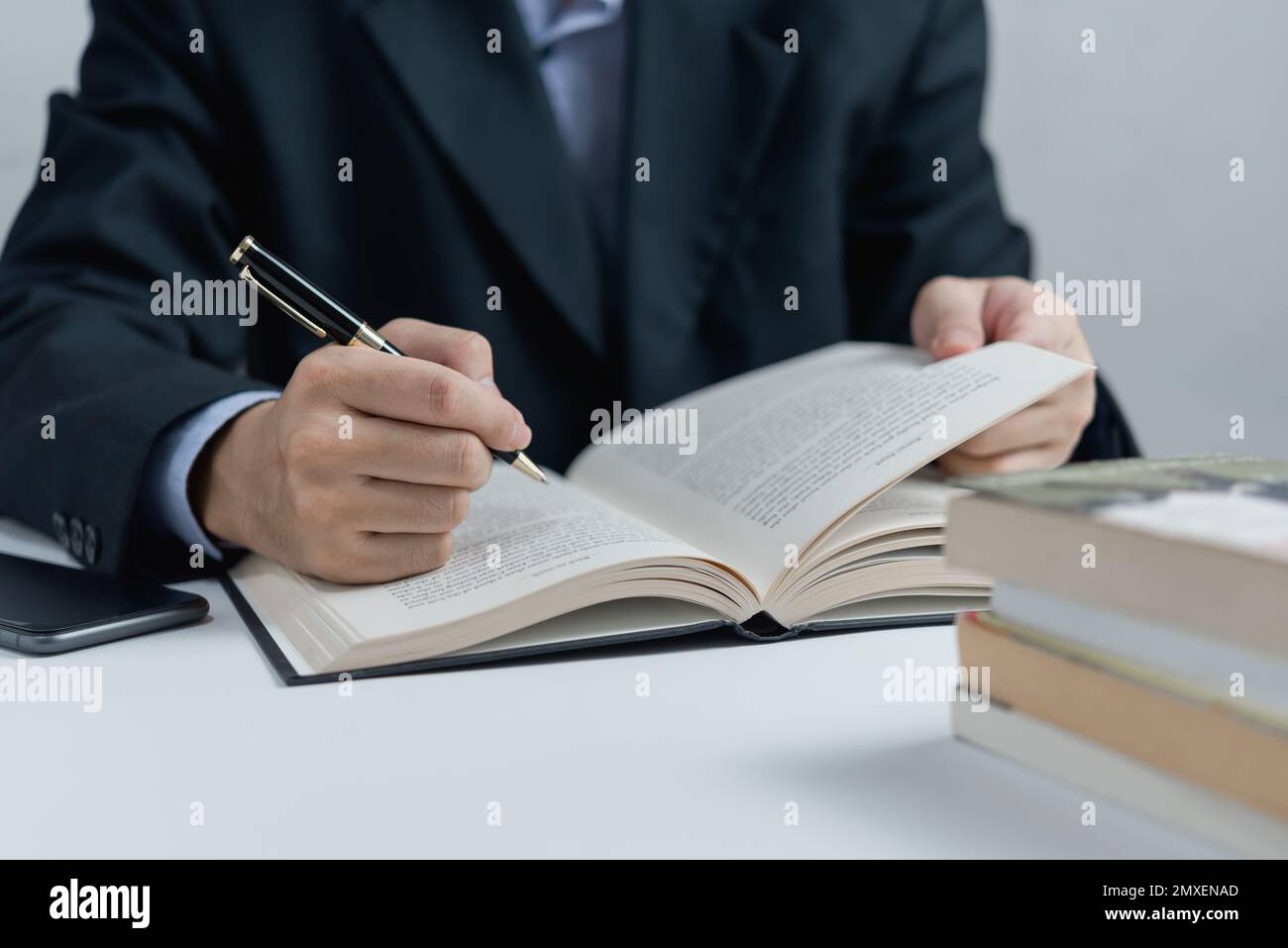 Businessperson reading and writing on book.education studying knowledge ...