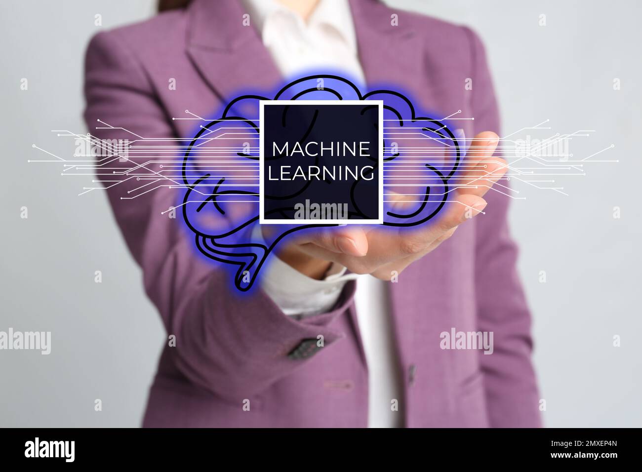 Woman demonstrating digital image of brain on light grey background ...