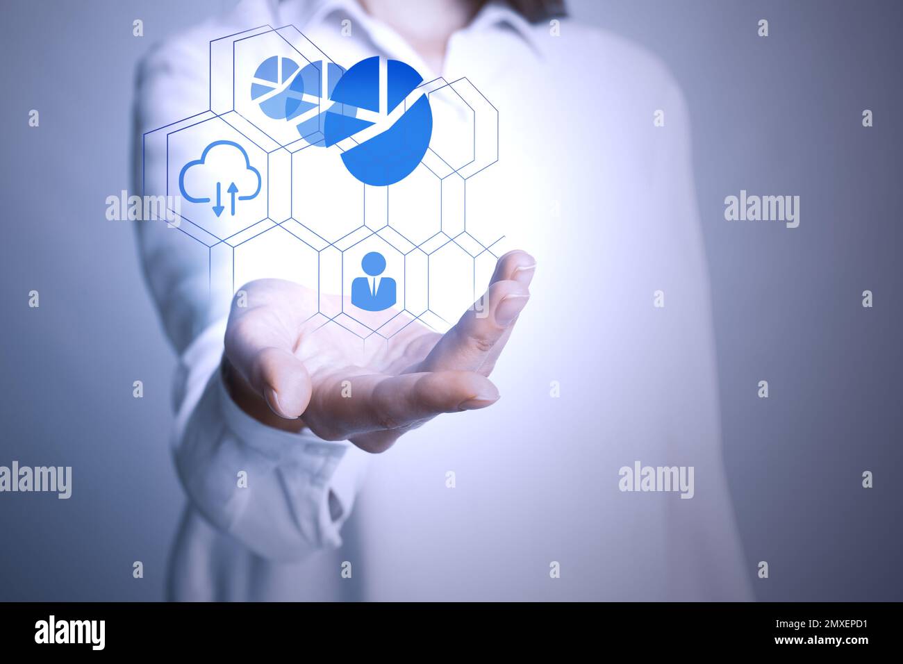 Woman demonstrating icons of data management system on grey background ...