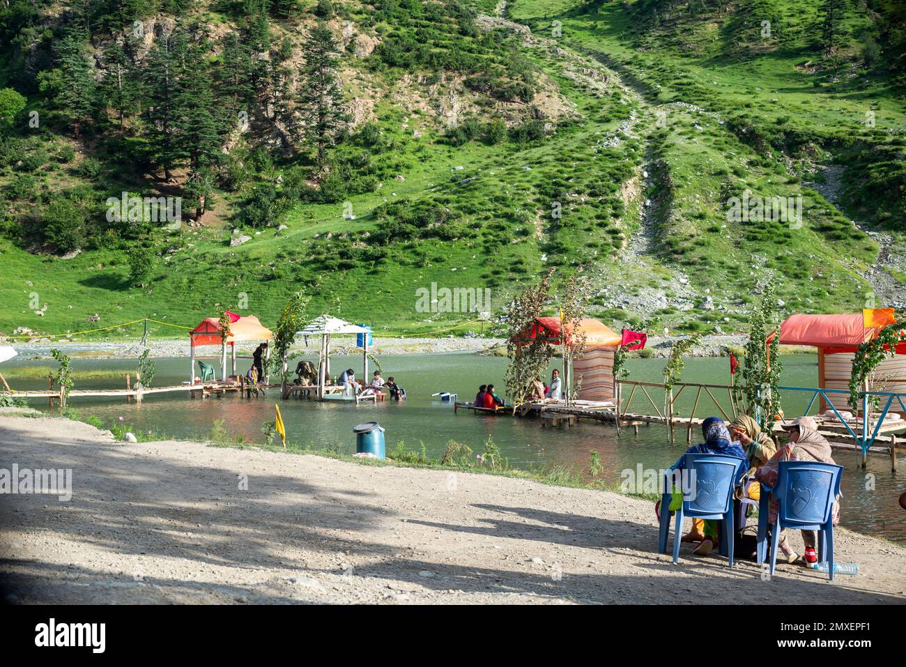 Pakistani people enjoying fresh air on the river in summer time, Swat ...
