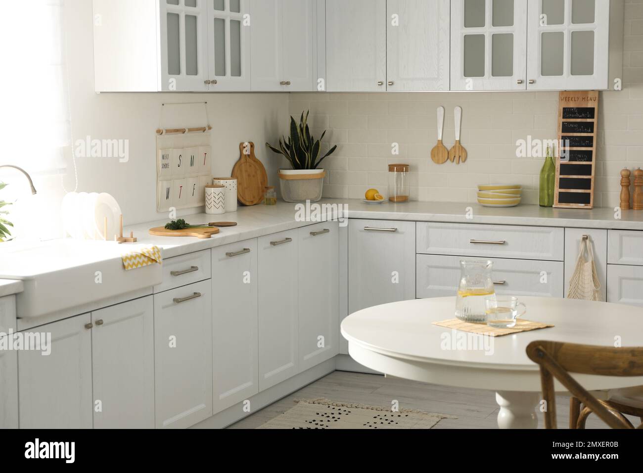 Elegant kitchen interior design with white round table Stock Photo - Alamy