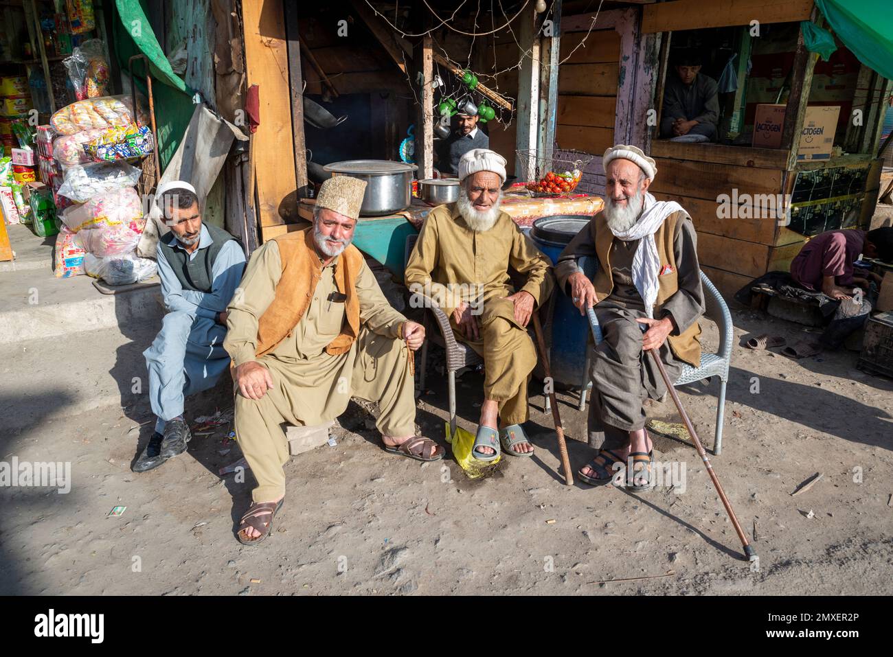 Four men in traditional wear sitting outside, Boyun village, Swat ...