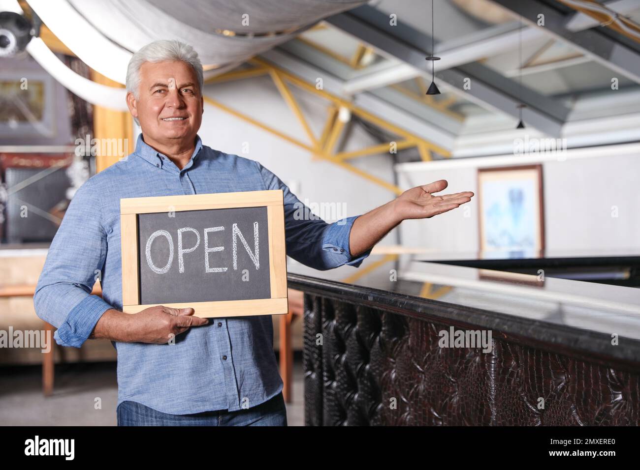 Cafe owner showing open sign hi-res stock photography and images - Alamy