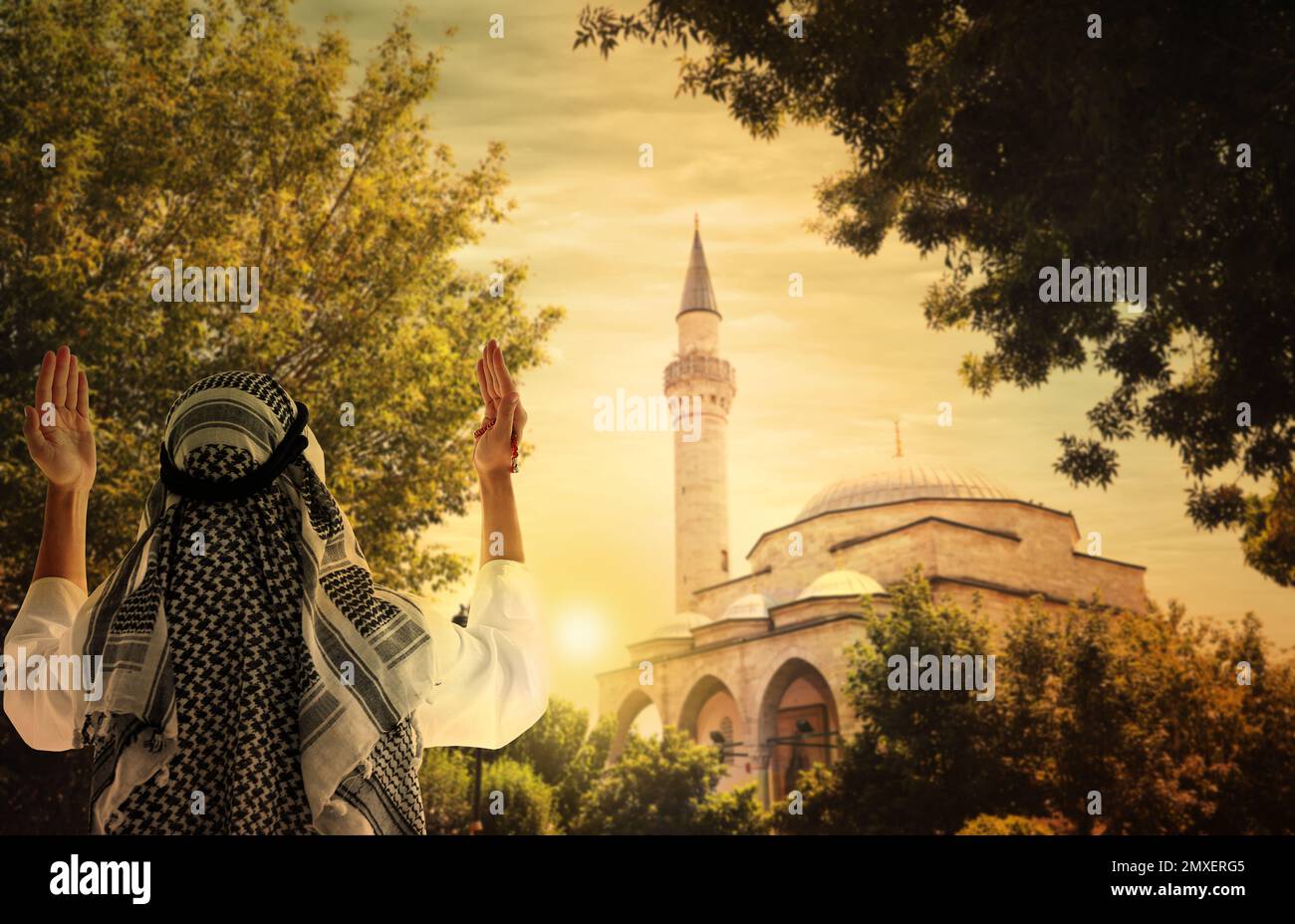 Muslim man praying near mosque at sunset Stock Photo - Alamy