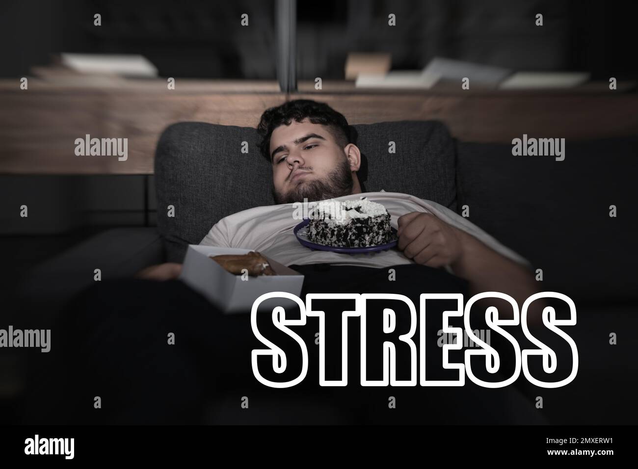 Depressed overweight man with sweets at home and word STRESS Stock ...