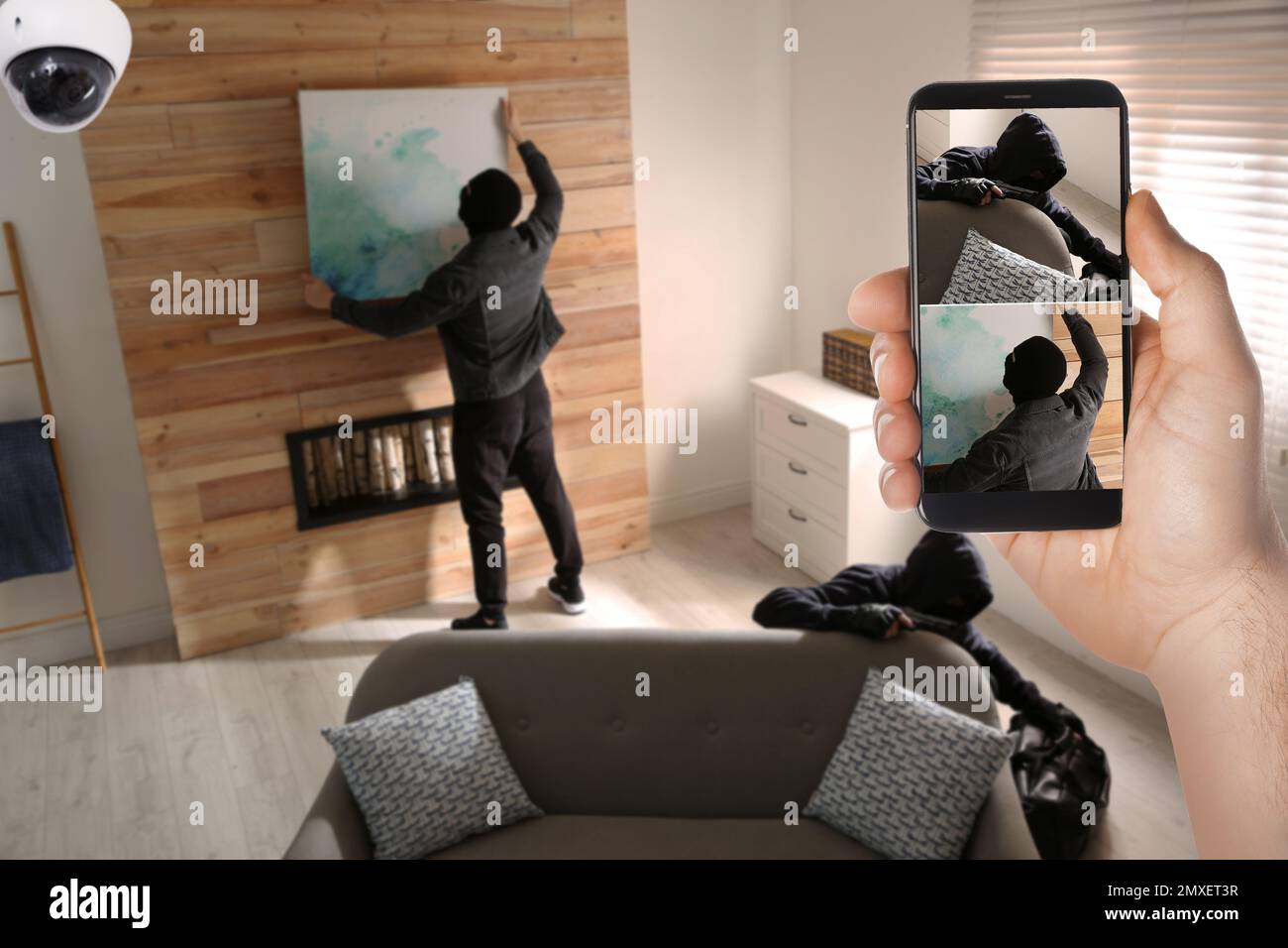 Man monitoring situation at his house with CCTV app on smartphone ... Man monitoring situation at his house with CCTV app on smartphone ...