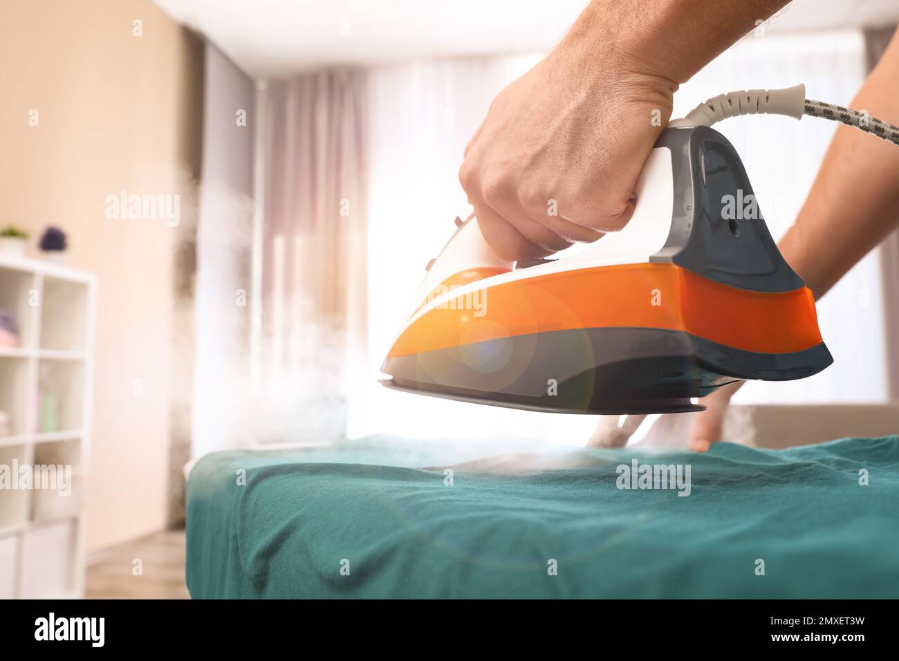 Man ironing clothes hi-res stock photography and images - Alamy