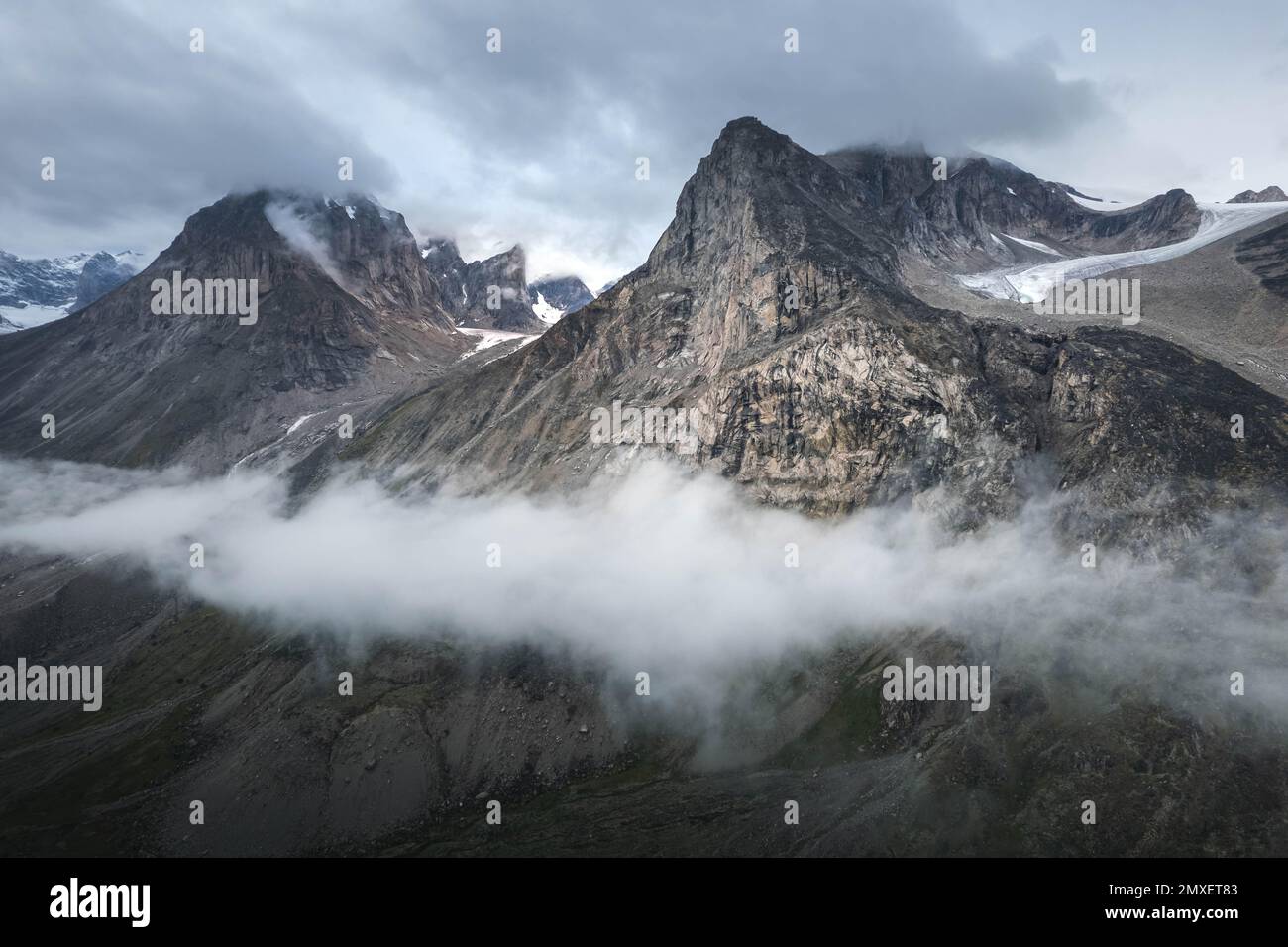 Southwest face of Mt. Thor, highest vertical cliff on Earth, on a ...