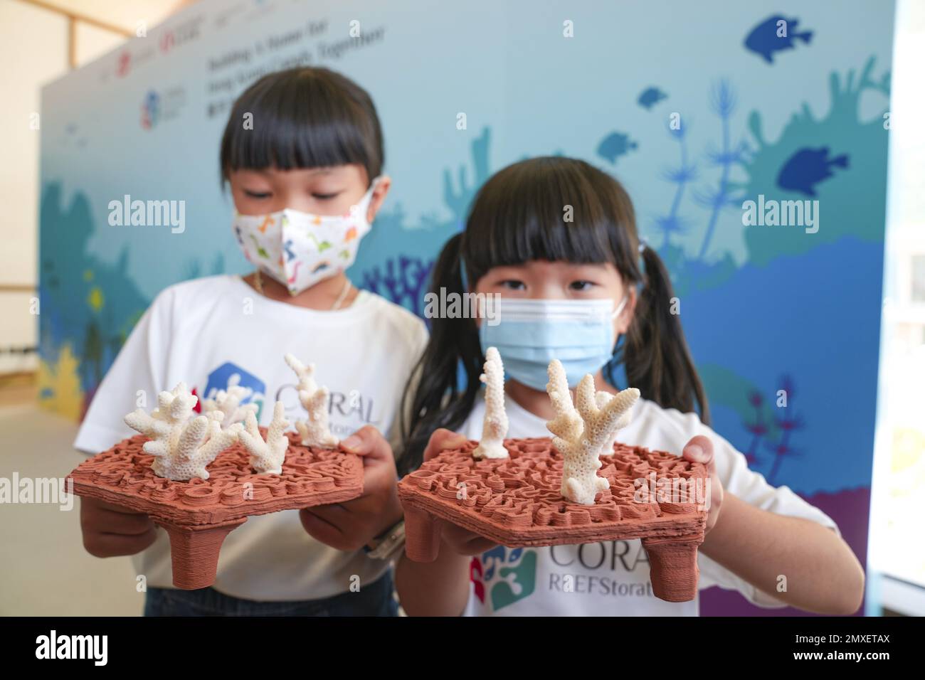 Children poses with 3D printed artificial reef structure during the ...