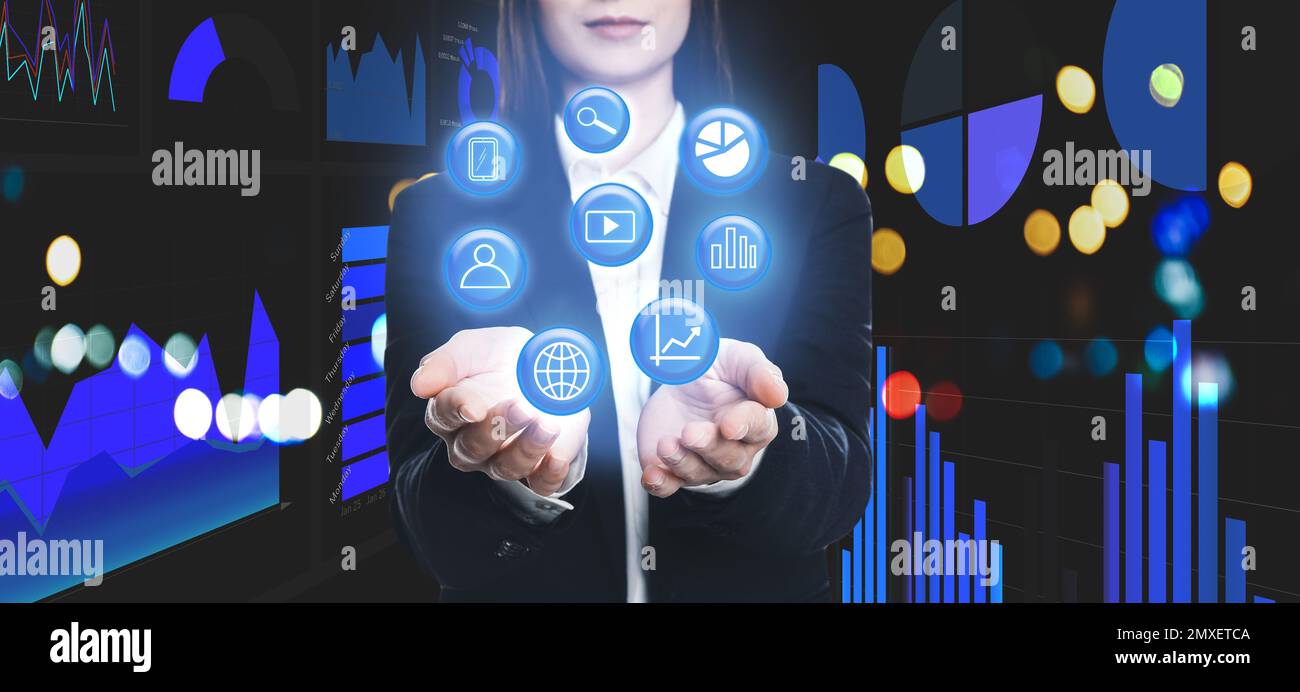 Woman demonstrating icons of data management system and digital charts ...