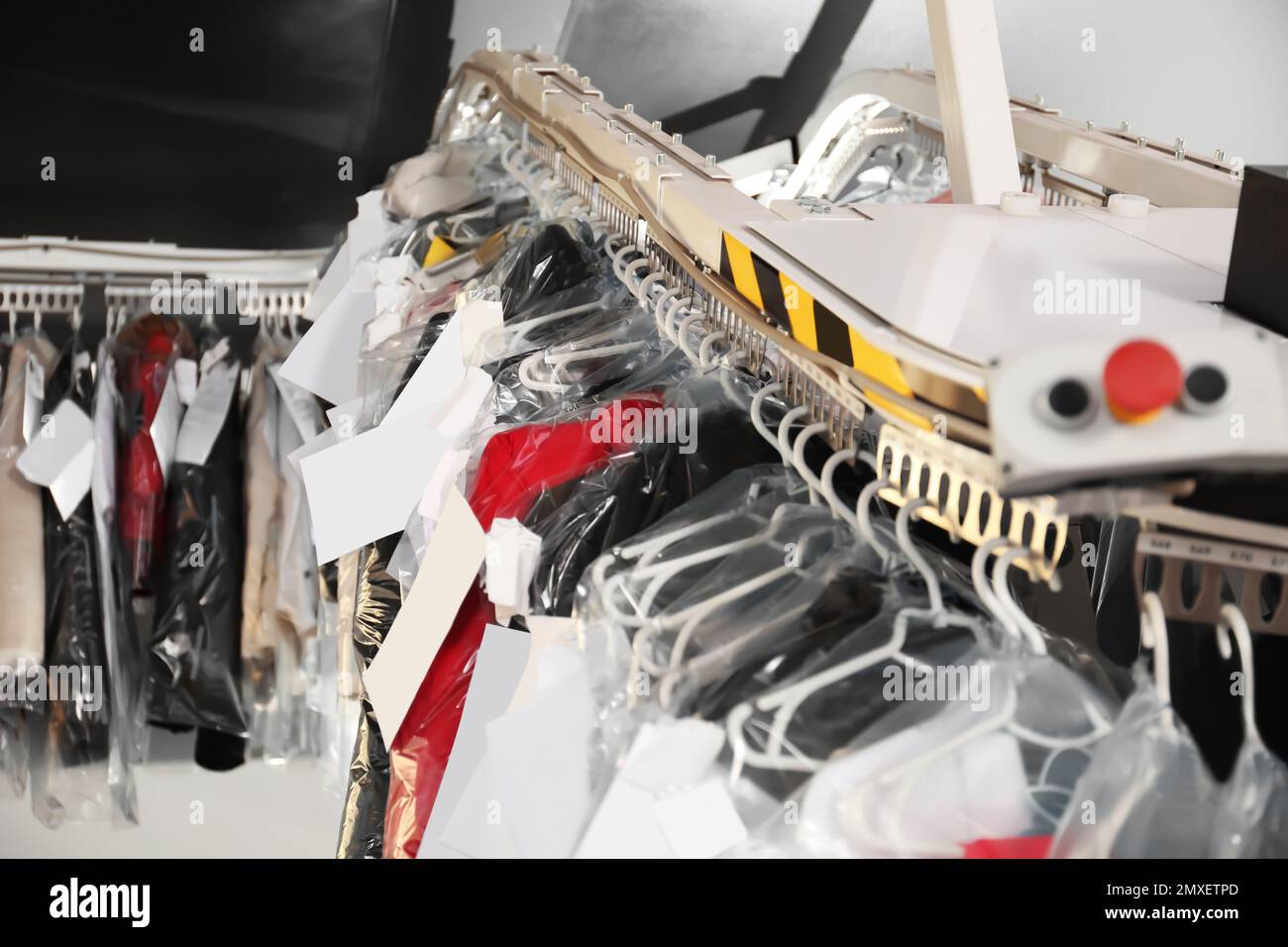Hangers with clothes on garment conveyor at dry-cleaner's Stock Photo ...
