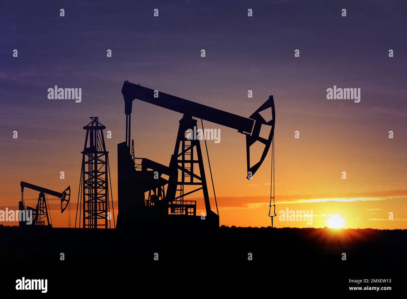 Silhouettes of crude oil pumps at sunset Stock Photo - Alamy