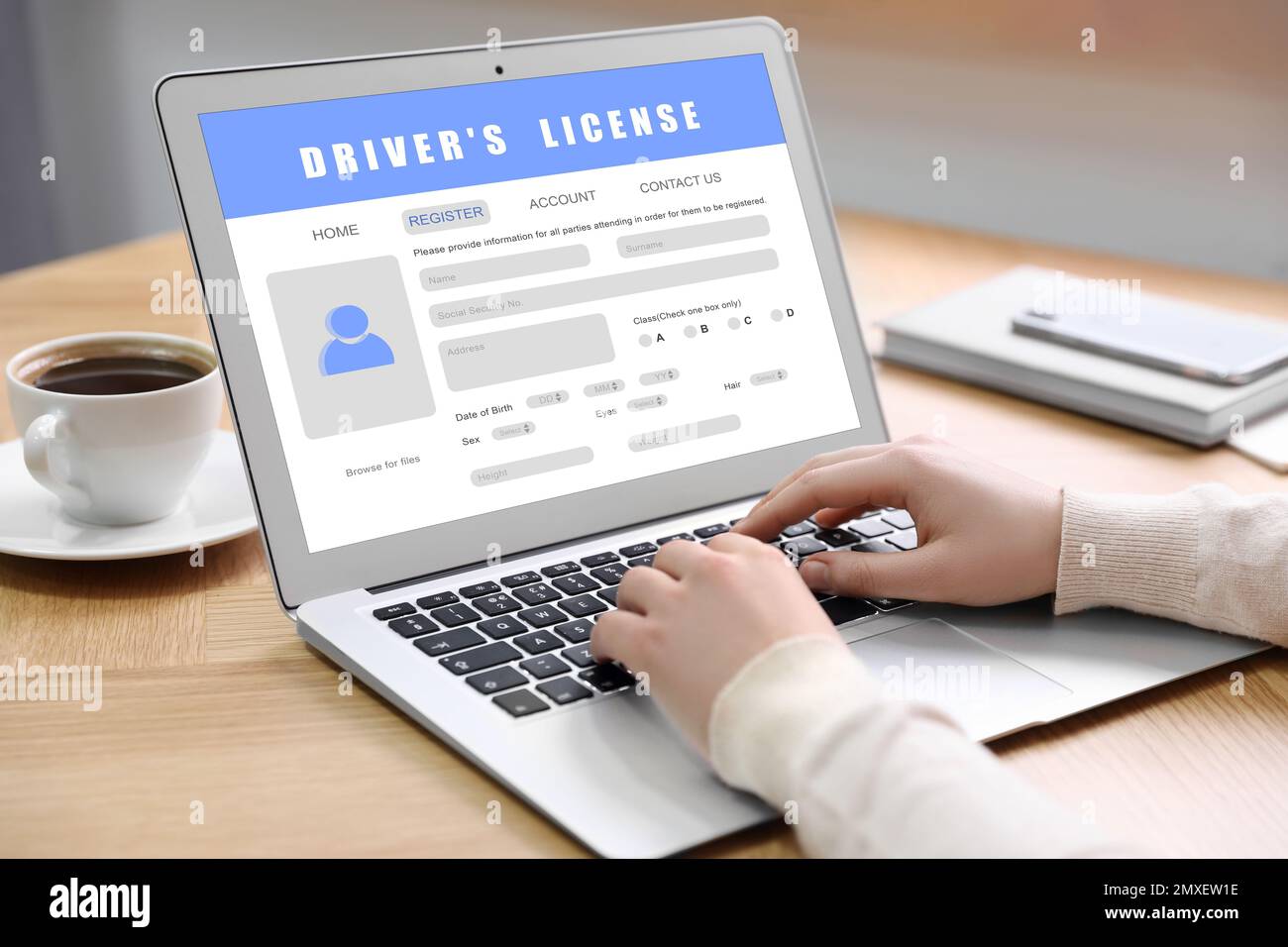Woman filling in driver's license form online on website using laptop, closeup Stock Photo - Alamy