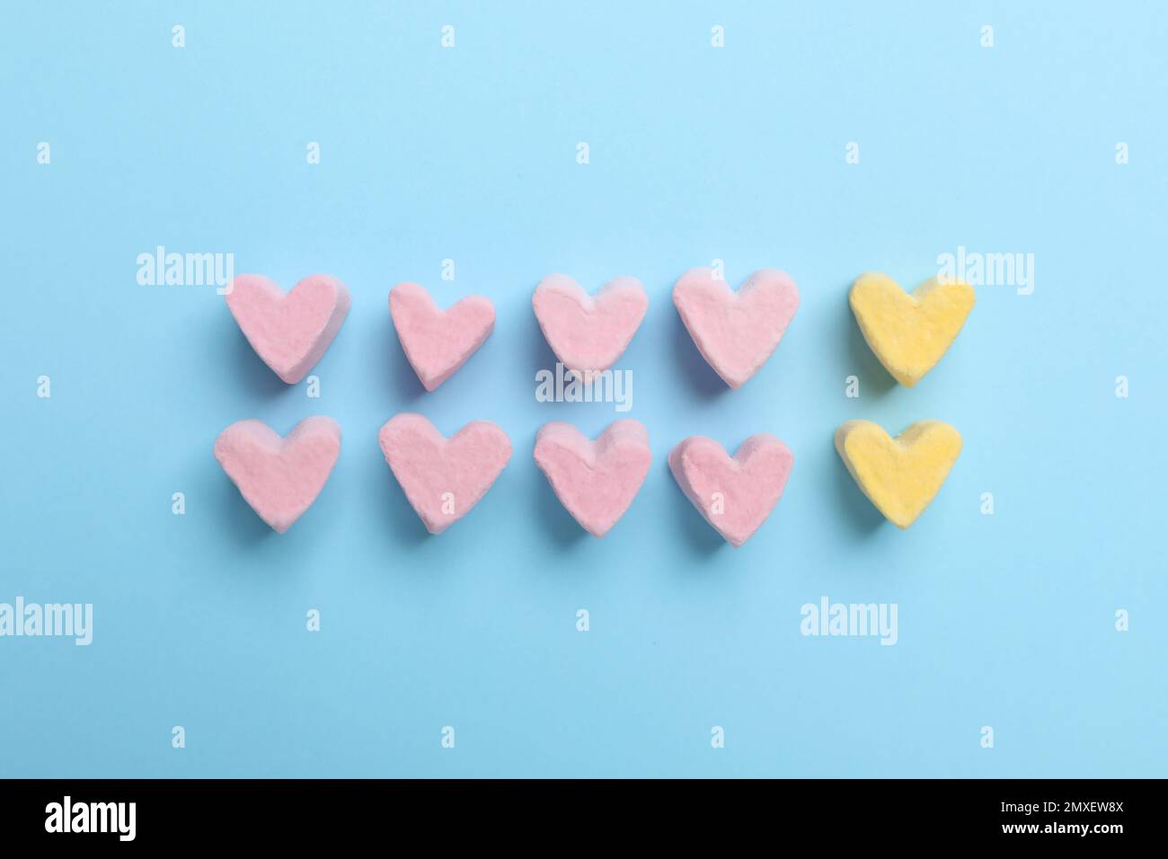 Flat lay composition with marshmallow hearts on light blue background ...