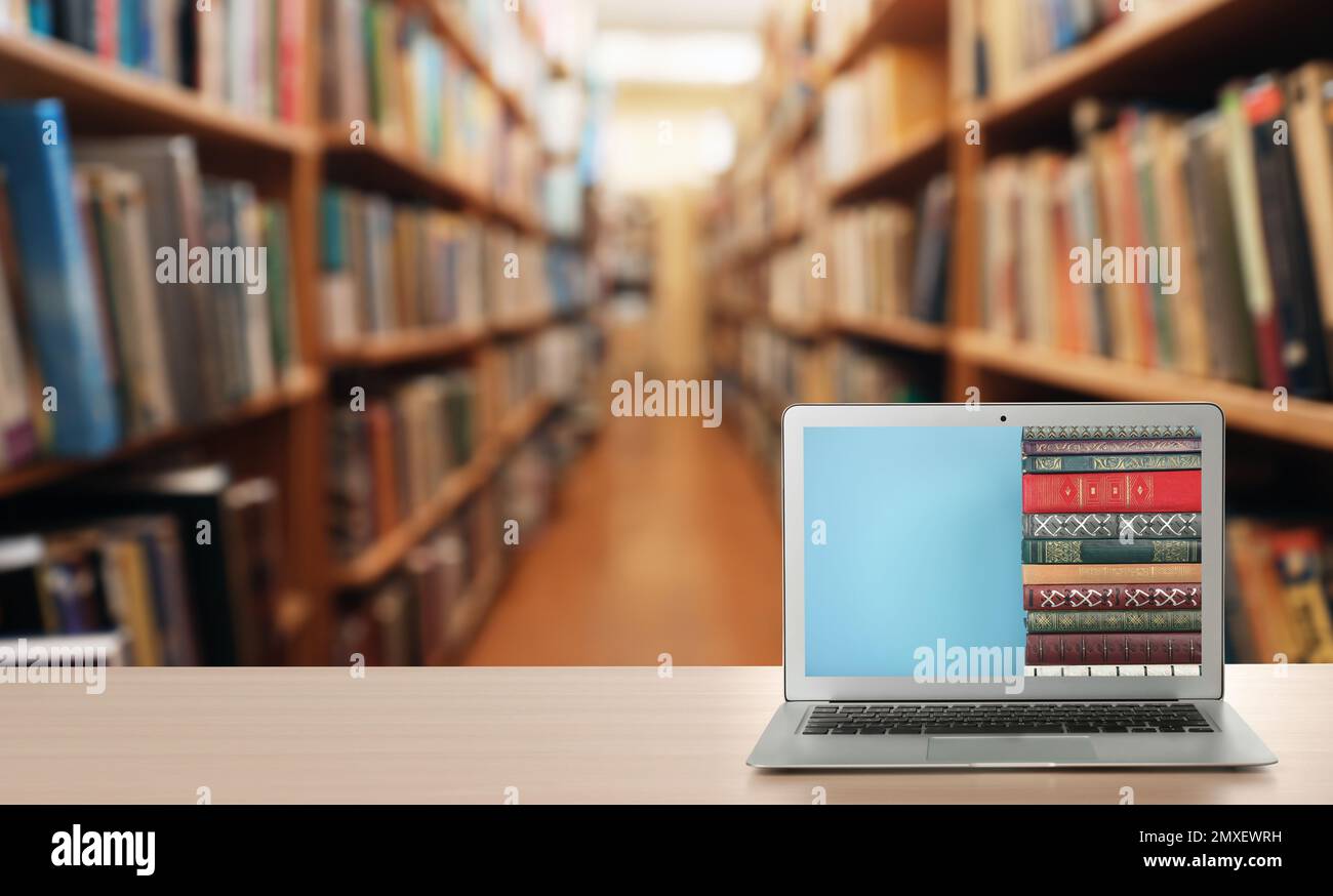 Digital library concept. Modern laptop on table indoors, space for text ...