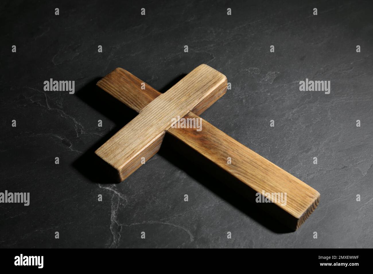Wooden Christian cross on black slate table. Religion concept Stock ...