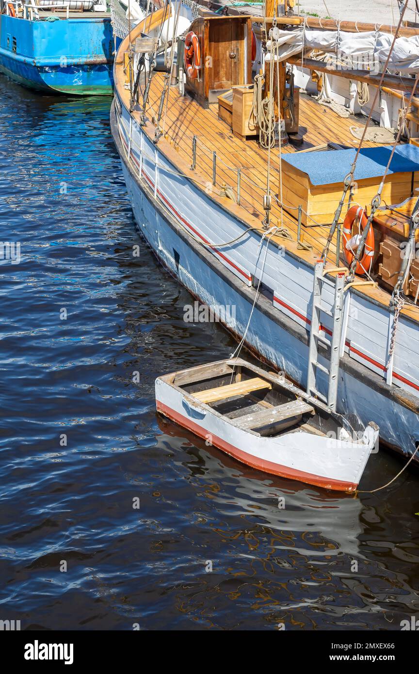 Historic sailing boat in the port with small rowing boat Stock Photo ...
