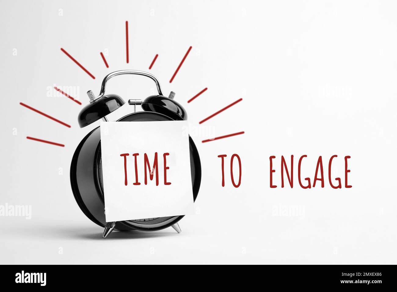 Alarm clock with note and phrase TIME TO ENGAGE on white background ...