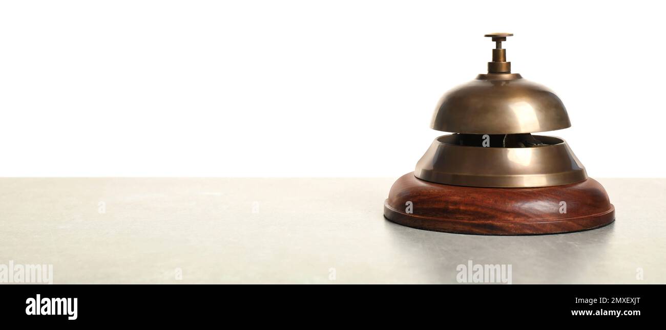 Hotel service bell on light table against white background Stock Photo ...