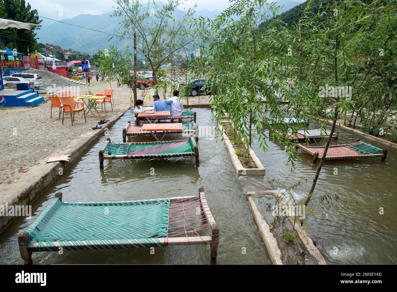 Pakistani people relaxing on charpai (wooden beds) on Swat River in ...