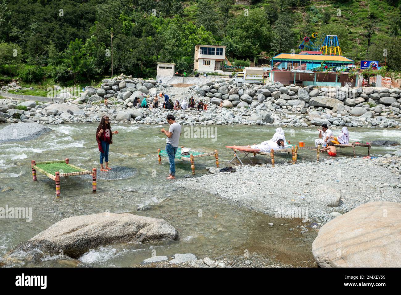Pakistani people enjoy fresh on charpai (wooden beds) on the banks of ...