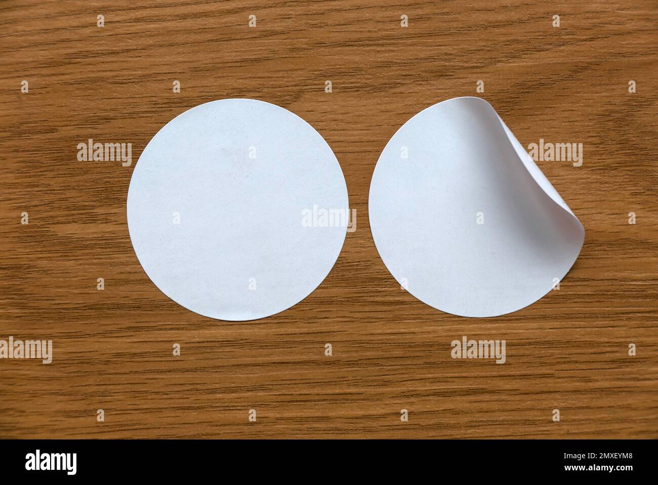 Blank white round stickers straightened and with folded corner on ...