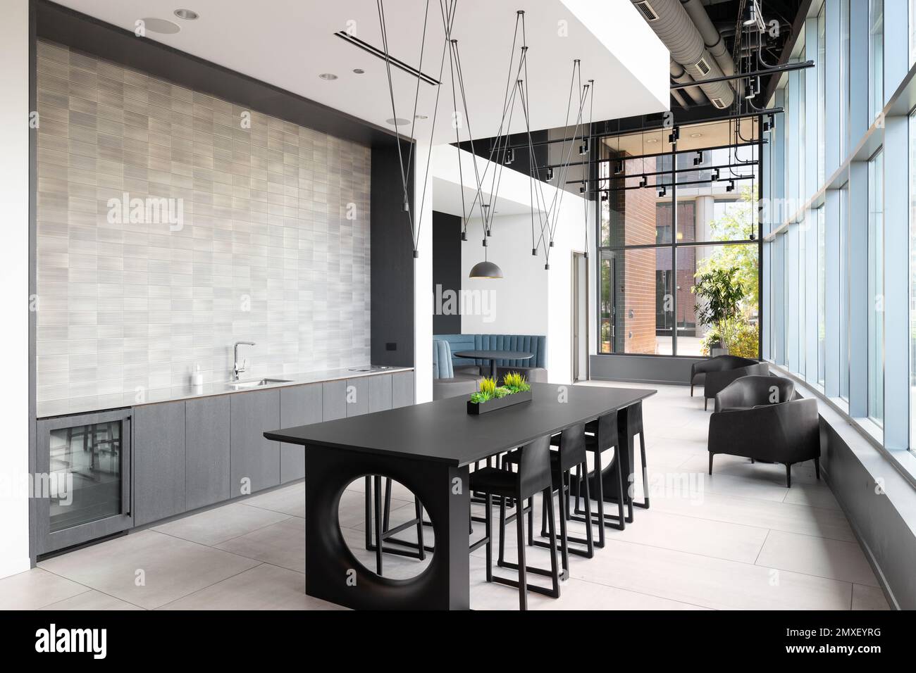 A modern and cozy entertaining space with a fancy light fixture over ...