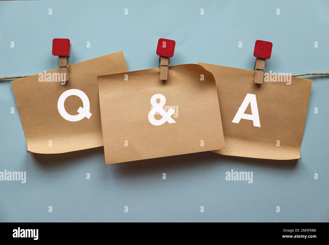 Three brown paper hanging on the rope written with letter Q, A and ...