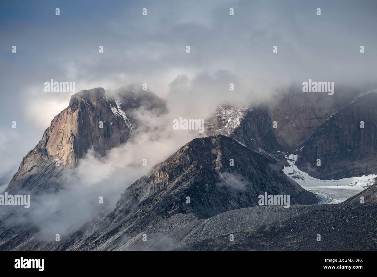 Dark atmospheric surreal landscape with dark rocky mountain top in low ...