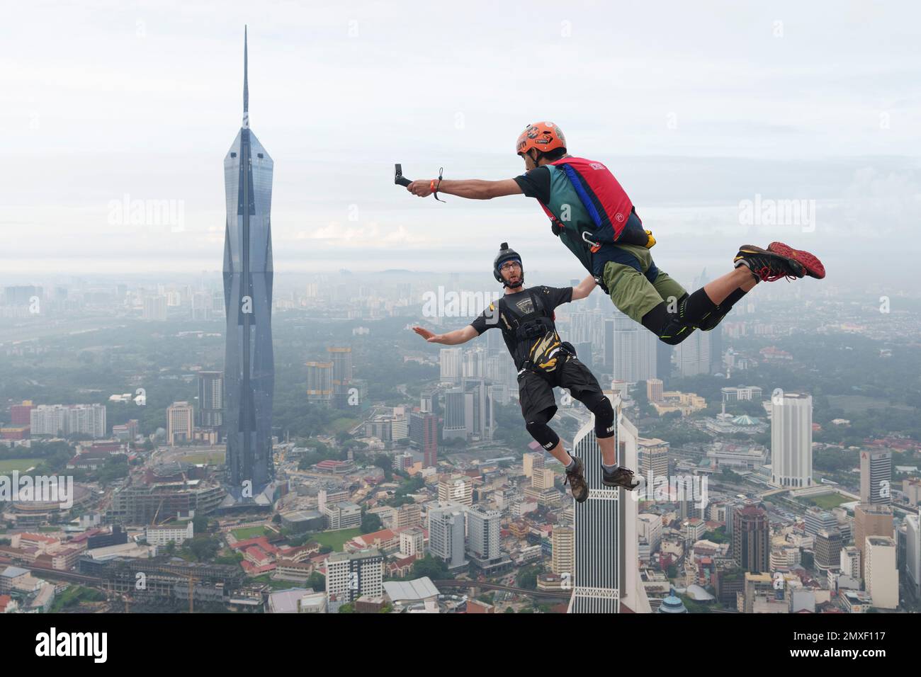 A pair of BASE jumpers dive from the Kuala Lumpur Tower during the KL Tower International Jump ...