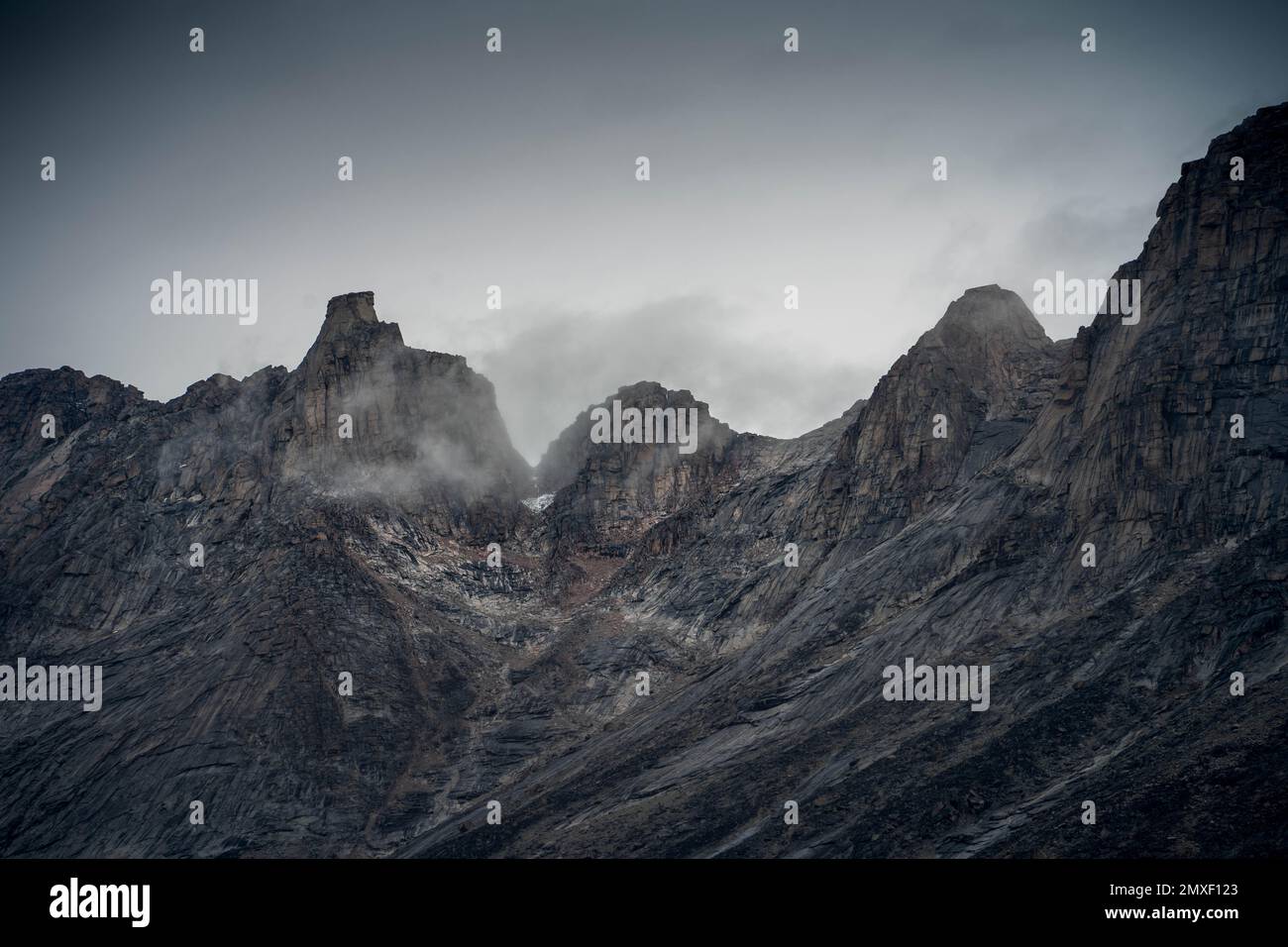 Southwest face of Mt. Thor, highest vertical cliff on Earth, on a ...