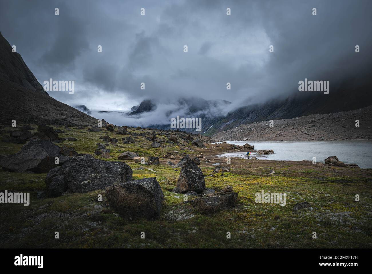 Southwest face of Mt. Thor, highest vertical cliff on Earth, on a ...