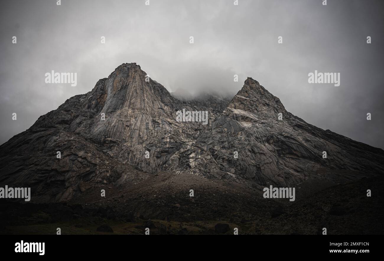 Southwest face of Mt. Thor, highest vertical cliff on Earth, on a ...