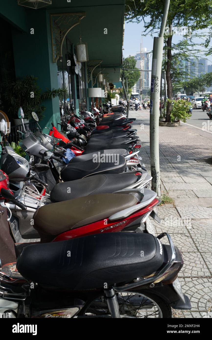 Mopeds parked on pavement Stock Photo - Alamy